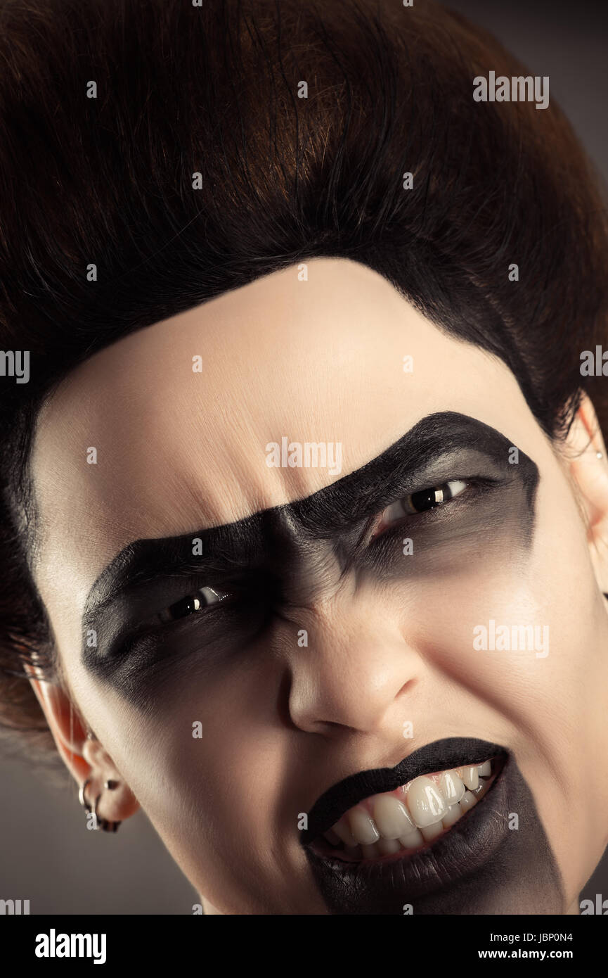 aggressive woman face with creative dark makeup closeup Stock Photo - Alamy