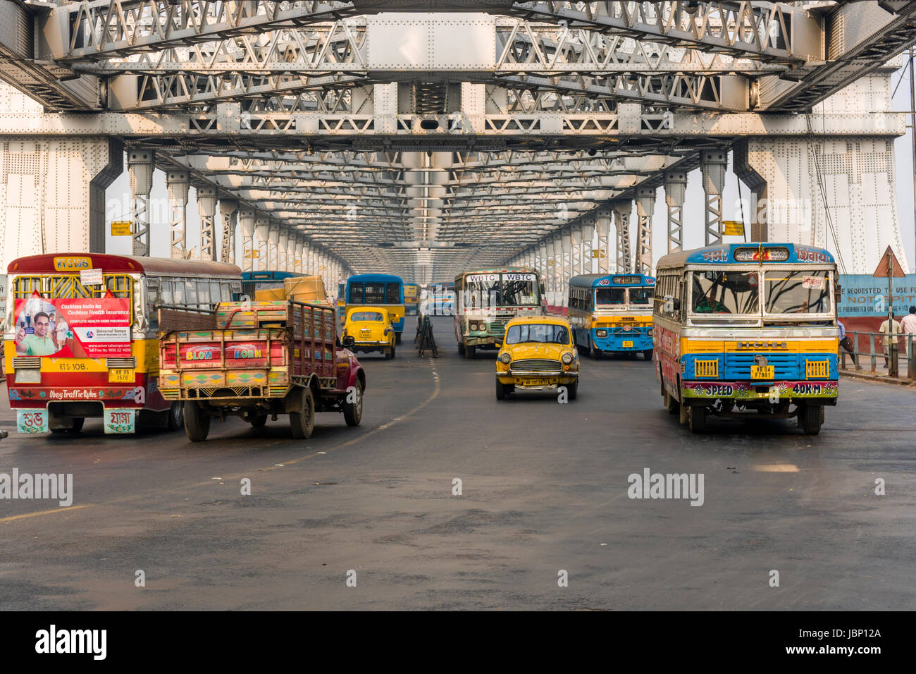 Cars, busses and trucks are crossing the steel construction of Howrah ...