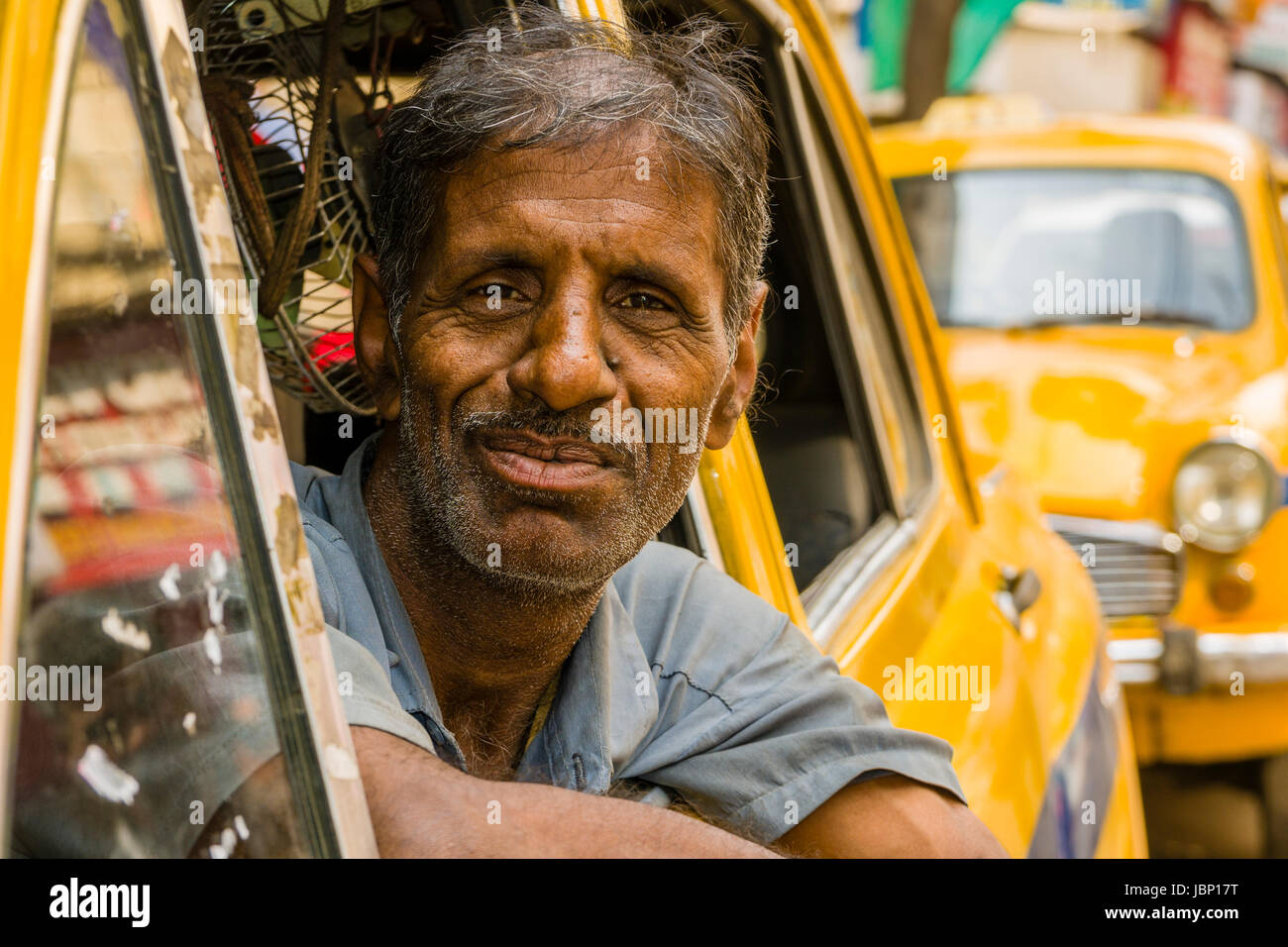 A taxi driver inside a yellow taxi, cab, is waiting for customers Stock ...