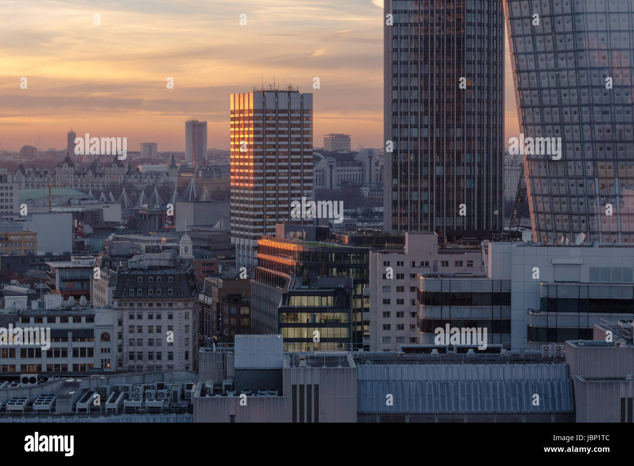 Skyscrapers under construction in London skyline against sunset horizon ...