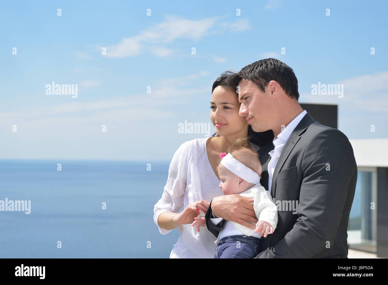 happy young family couple with beautiful new born baby have fun at home ...