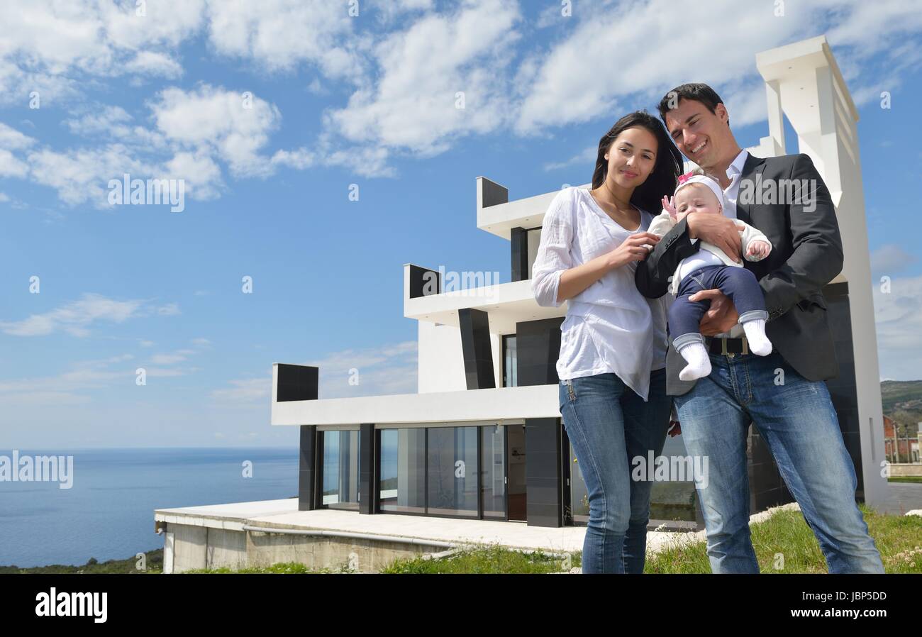 happy young family couple with beautiful new born baby have fun at home ...