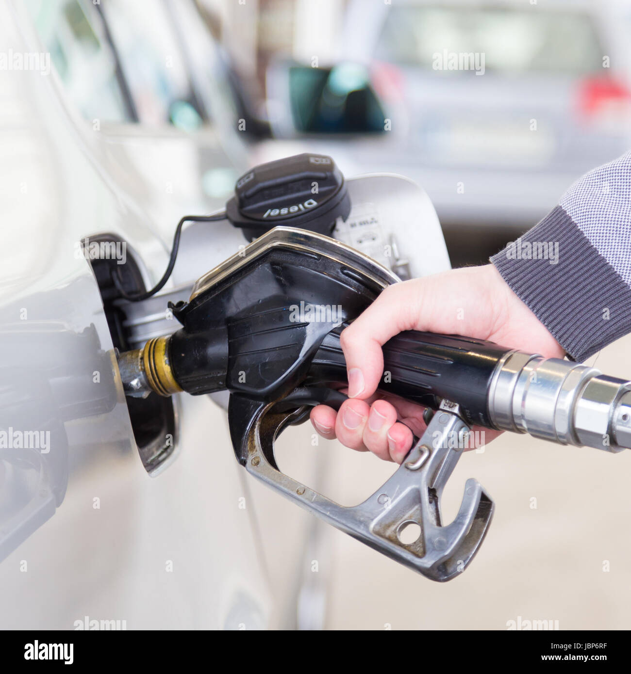 Petrol or gasoline being pumped into a motor vehicle car. Closeup of ...