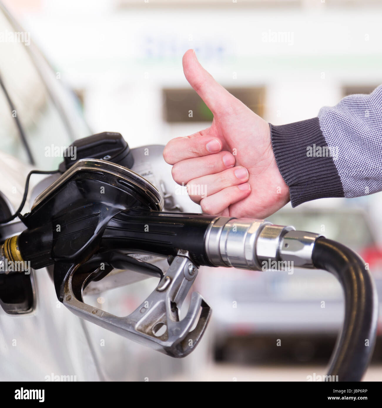 Petrol or gasoline being pumped into a motor vehicle car. Closeup of ...
