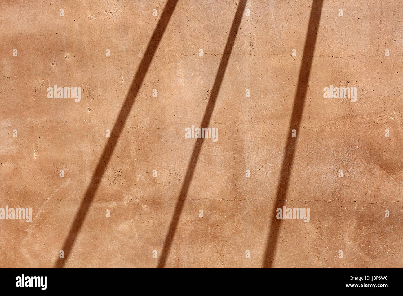 Adobe wall with three shadow lines Stock Photo - Alamy