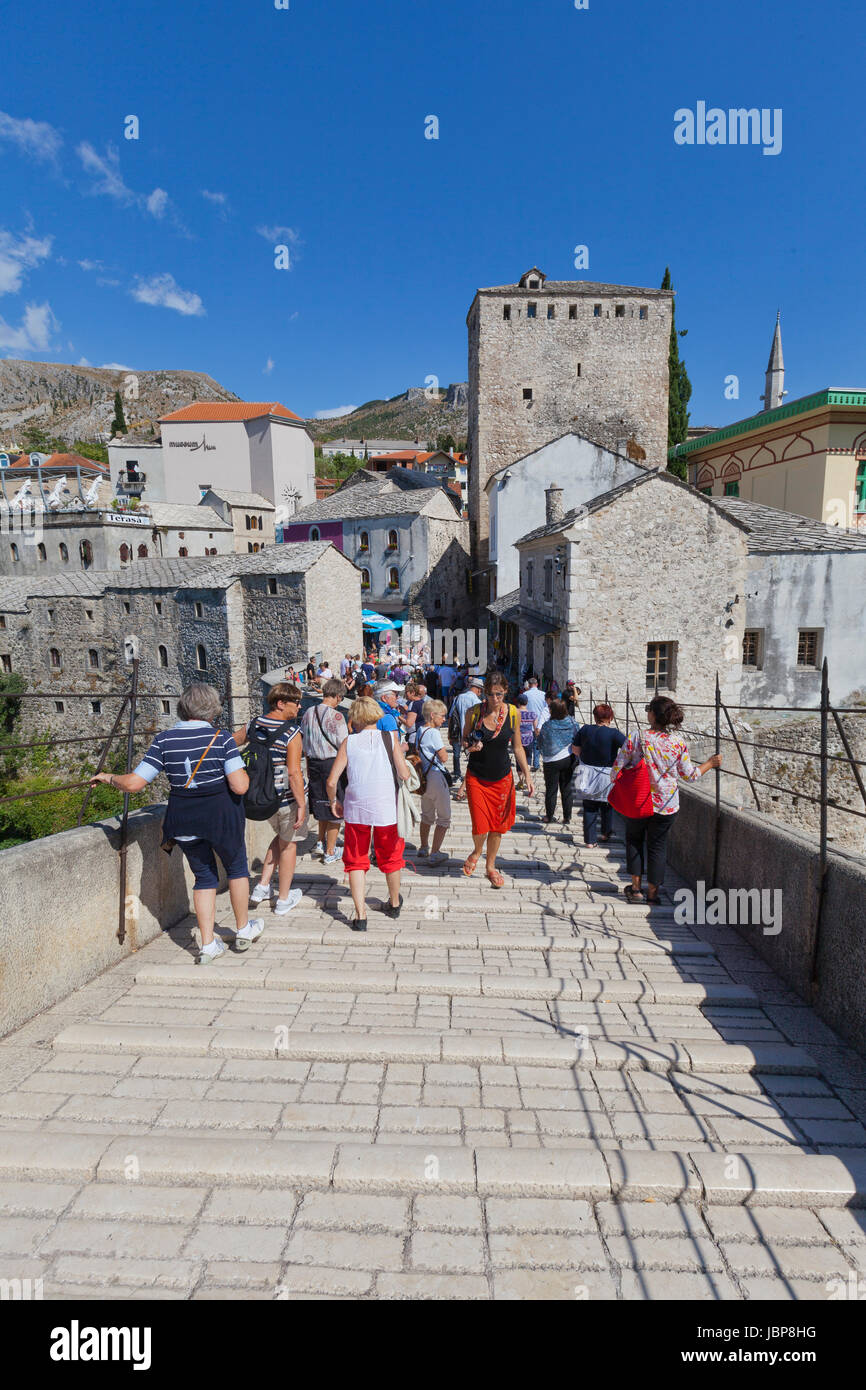 Tourists crossing Mostar bridge Stock Photo - Alamy