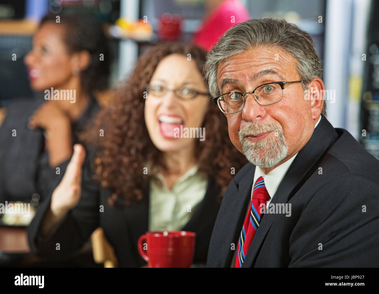 Frustrated businessman arguing with woman in cafeteria Stock Photo - Alamy