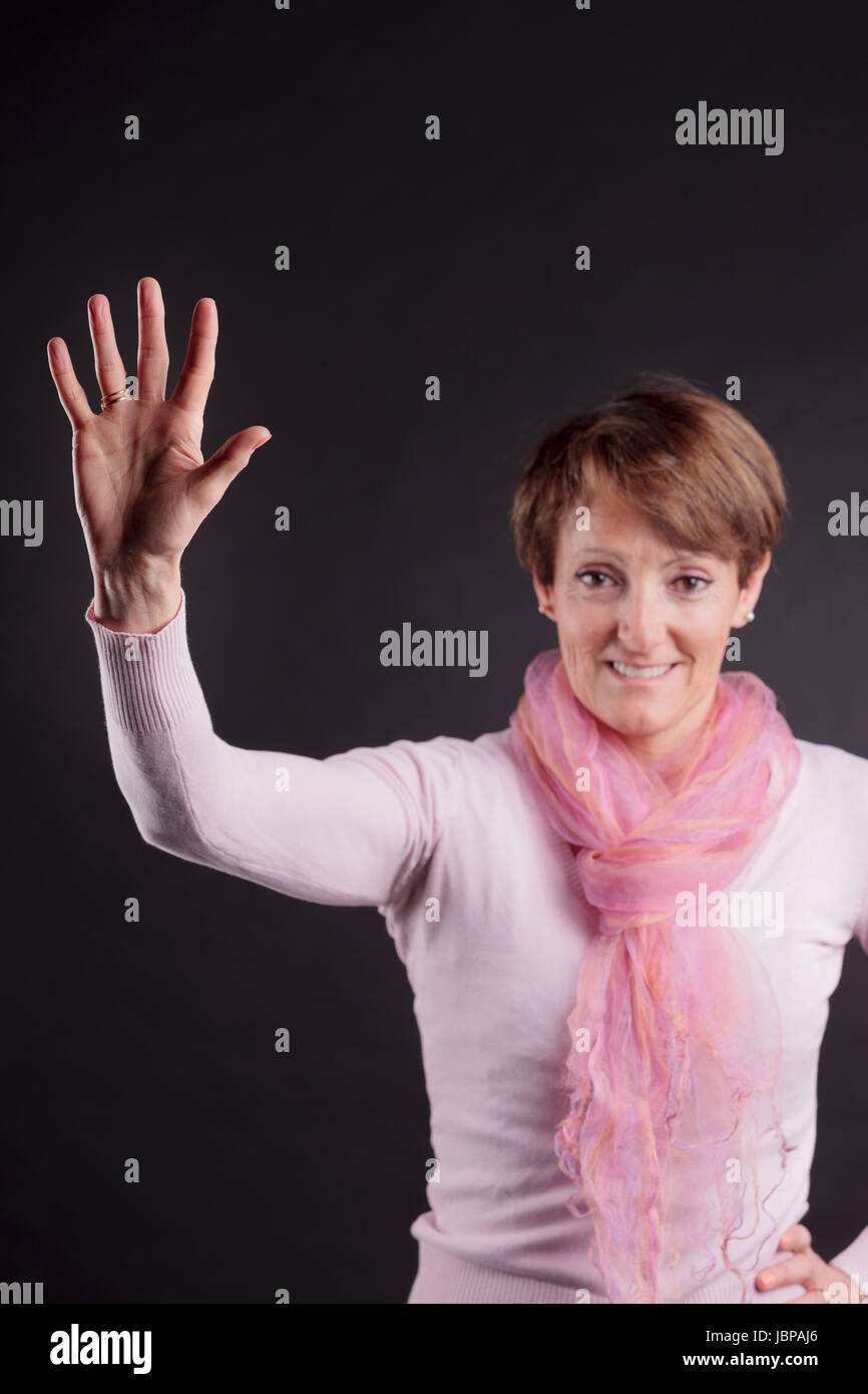mature woman with a raised hand Stock Photo - Alamy
