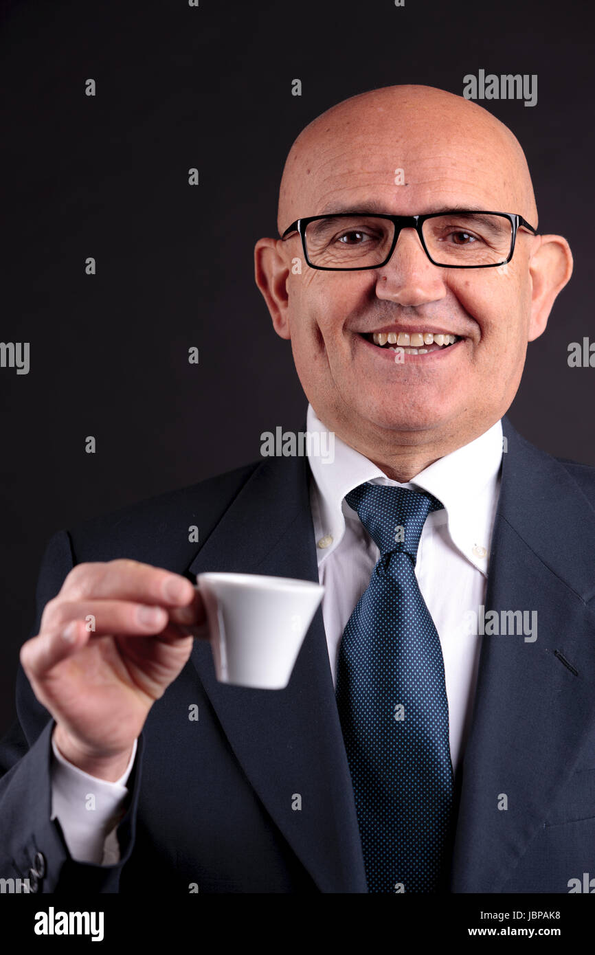 Happy mature bald businessman relaxing hi-res stock photography and ...