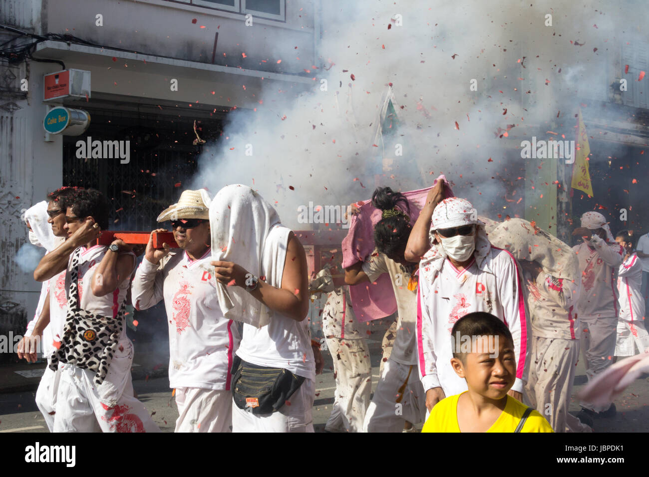 Carrying a statues of the gods under a hail of Chinese firecrackers in ...