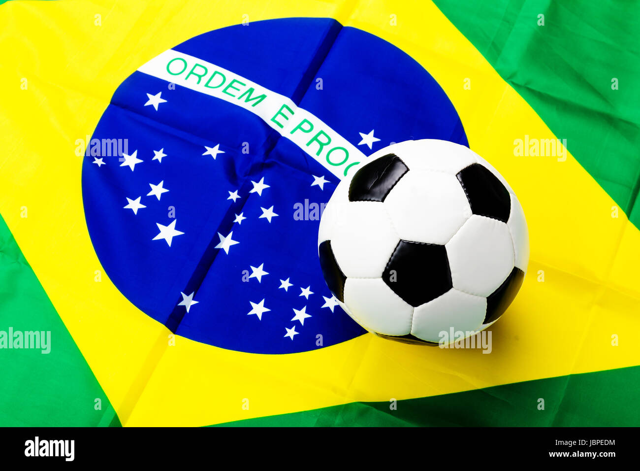 Waved Brazilian flag and football Stock Photo - Alamy