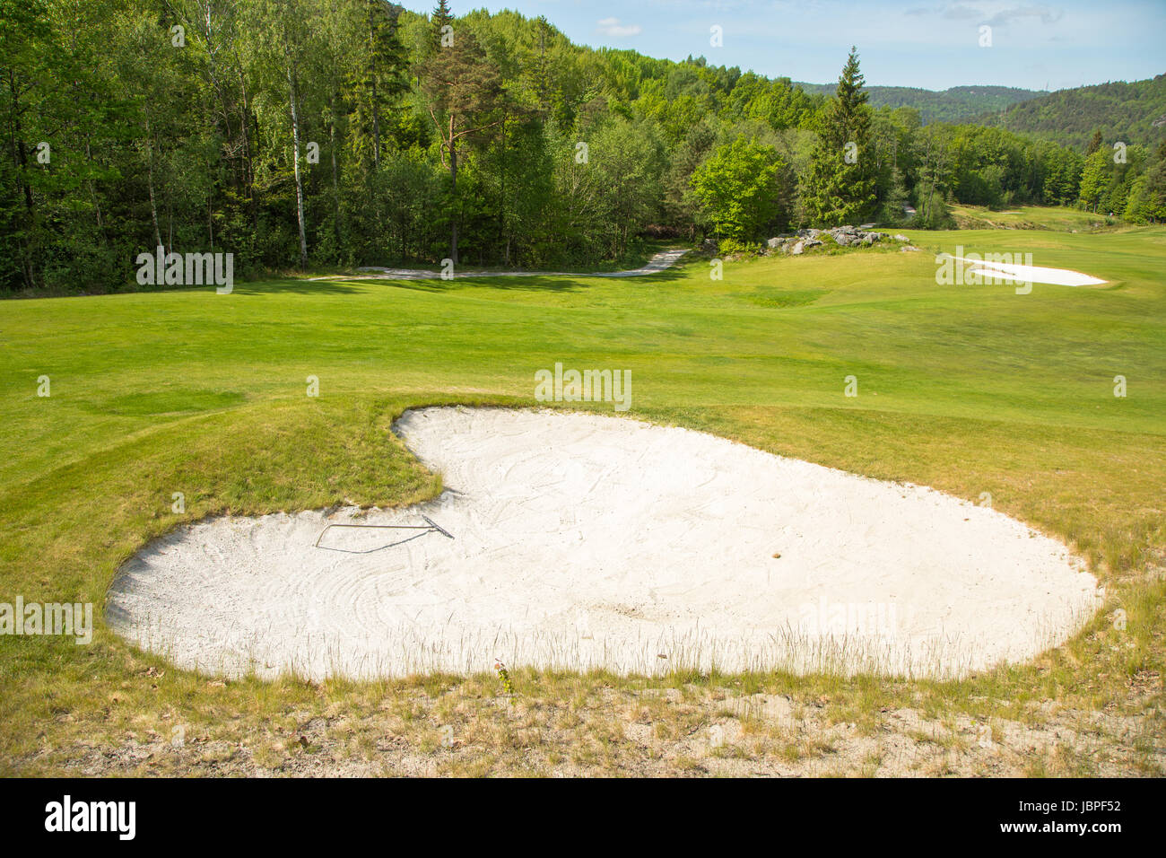 Sand trap in a golf course sand bunkers heart shape Stock Photo - Alamy