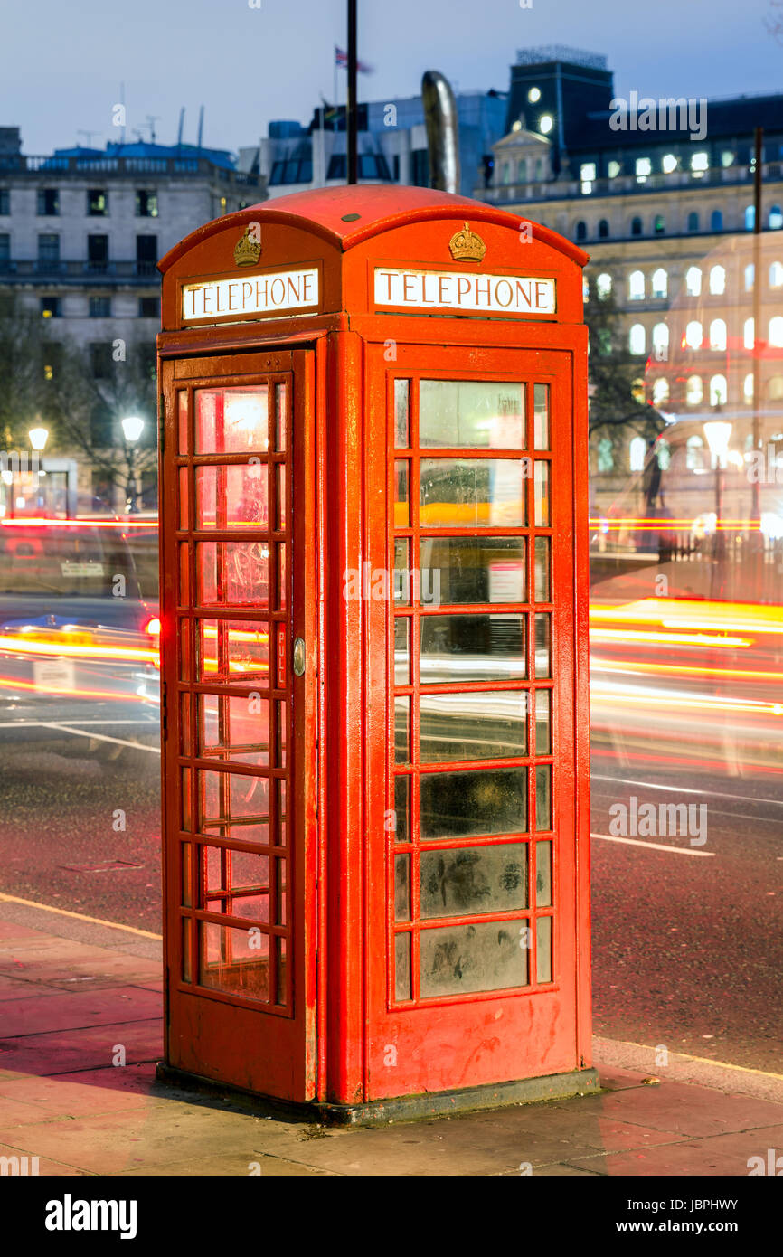 Red telephone box in street with historical architecture in London ...