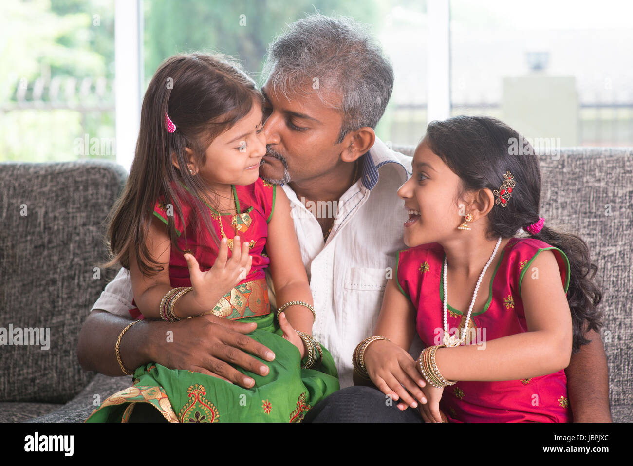 Indian daughter kissing father home hi-res stock photography and images ...