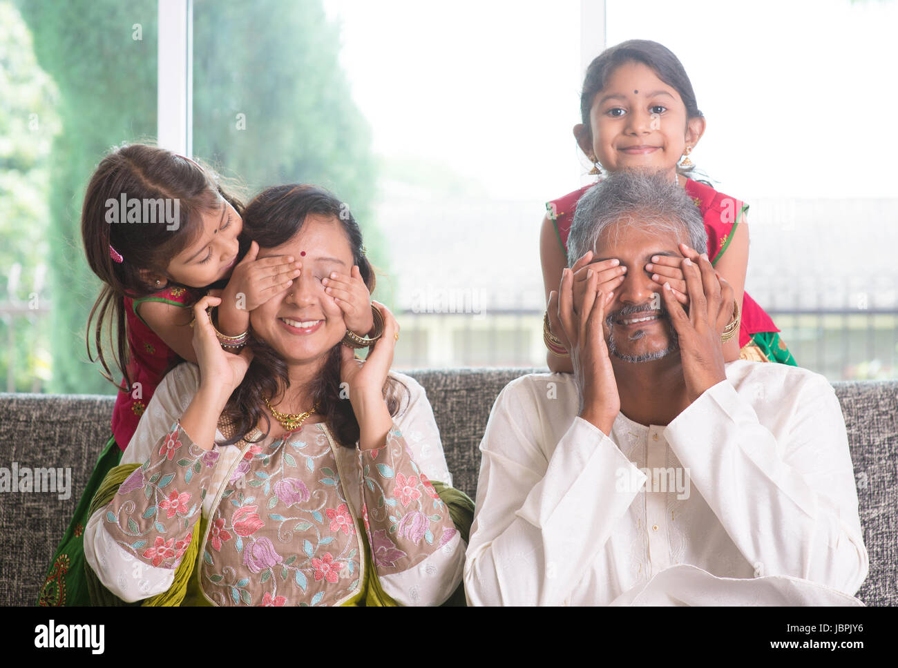 Indian family living lifestyle at home. Cute girls in traditional sari ...