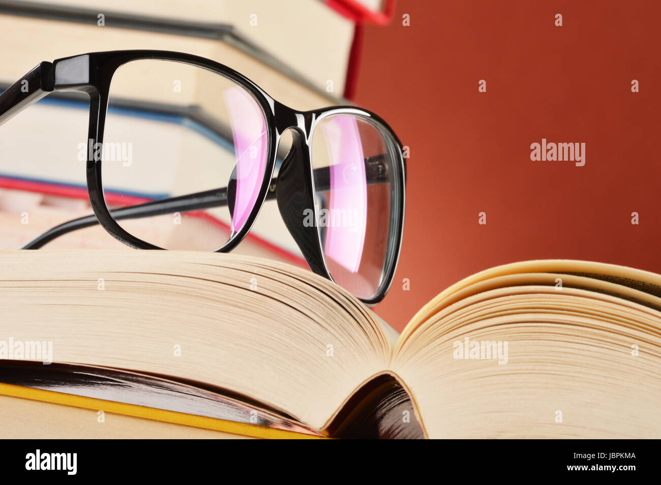 Composition with glasses and books on the table Stock Photo - Alamy