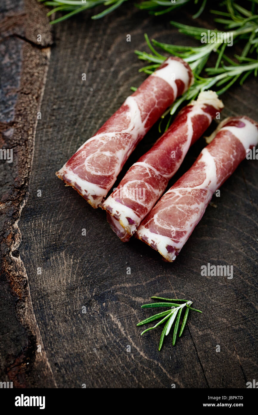 Coppa pork collar ham. Cold cuts on wood. Rustic ham prosciutto Stock ...