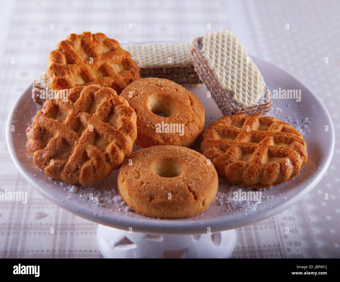 Biscuits of different kinds over a white ceramic stand Stock Photo - Alamy