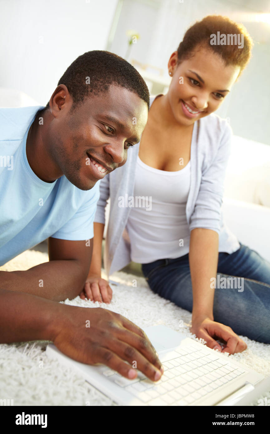 Image of young African couple networking at home Stock Photo - Alamy