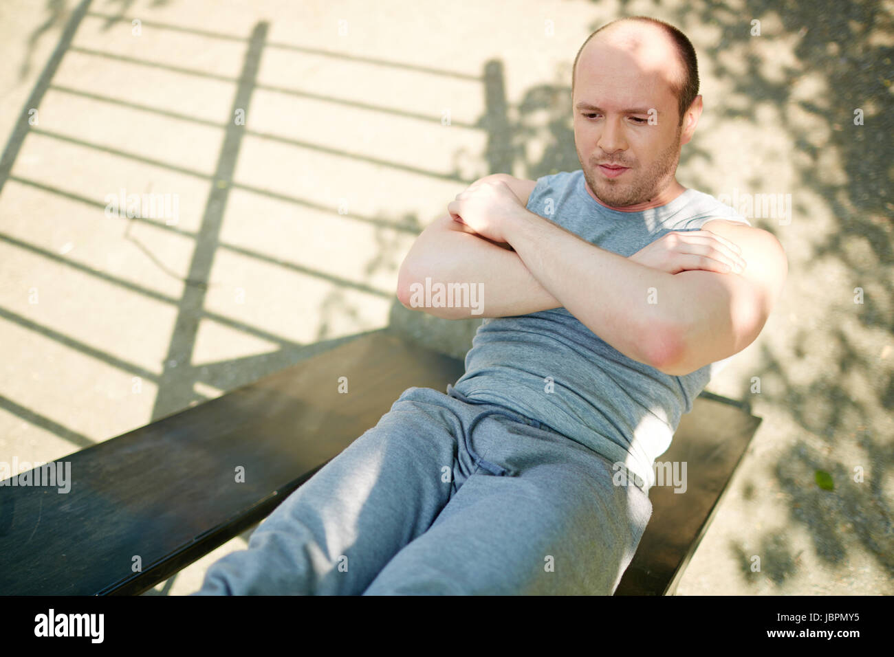 Young man doing physical exercise outside Stock Photo - Alamy
