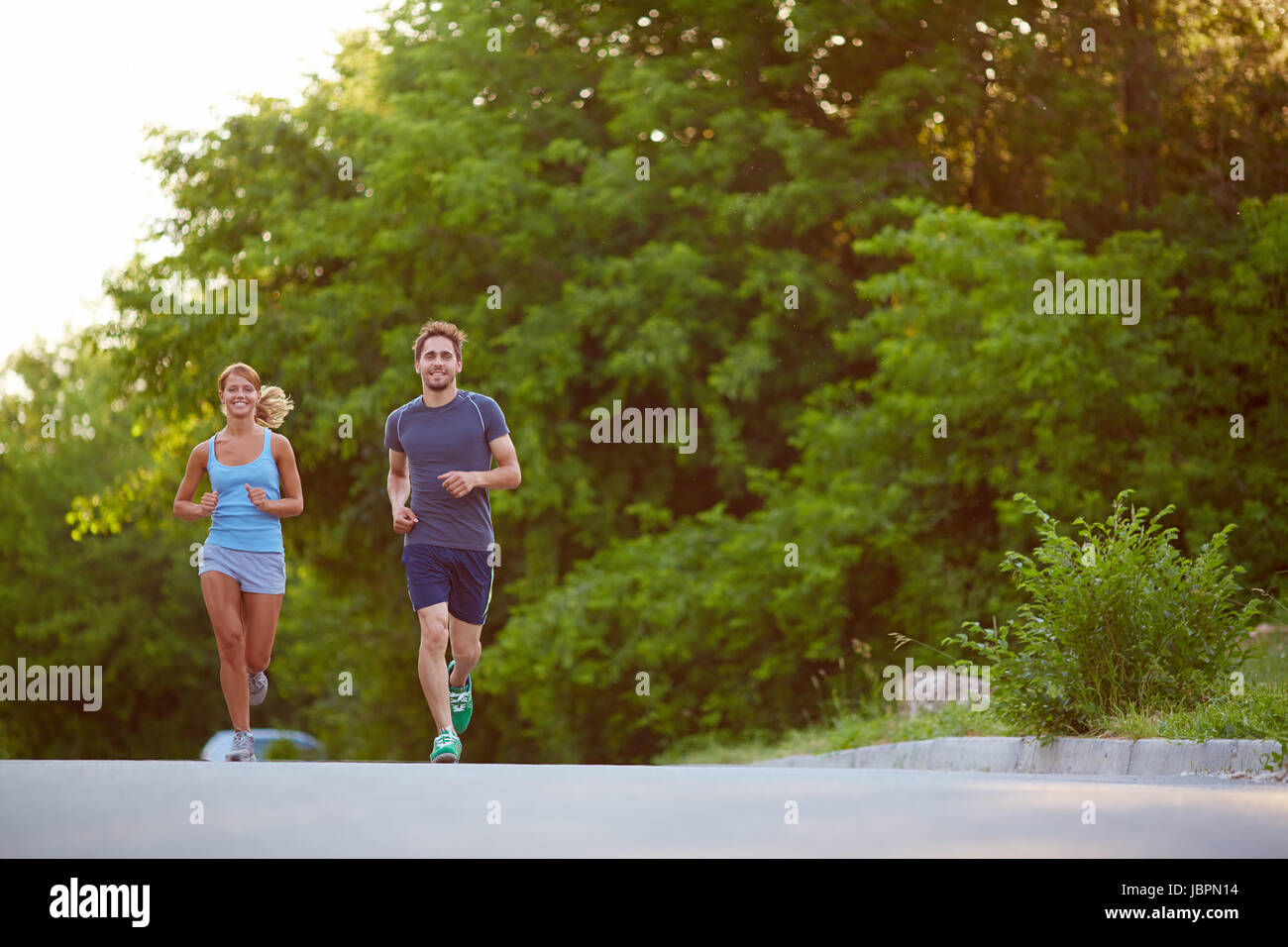 Photo of happy couple running outdoors Stock Photo - Alamy