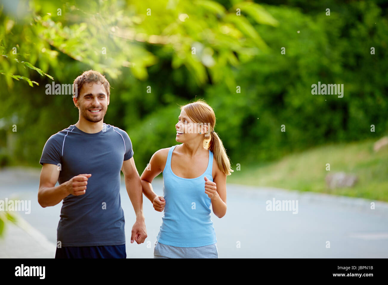 Photo of happy couple jogging on summer morning Stock Photo - Alamy