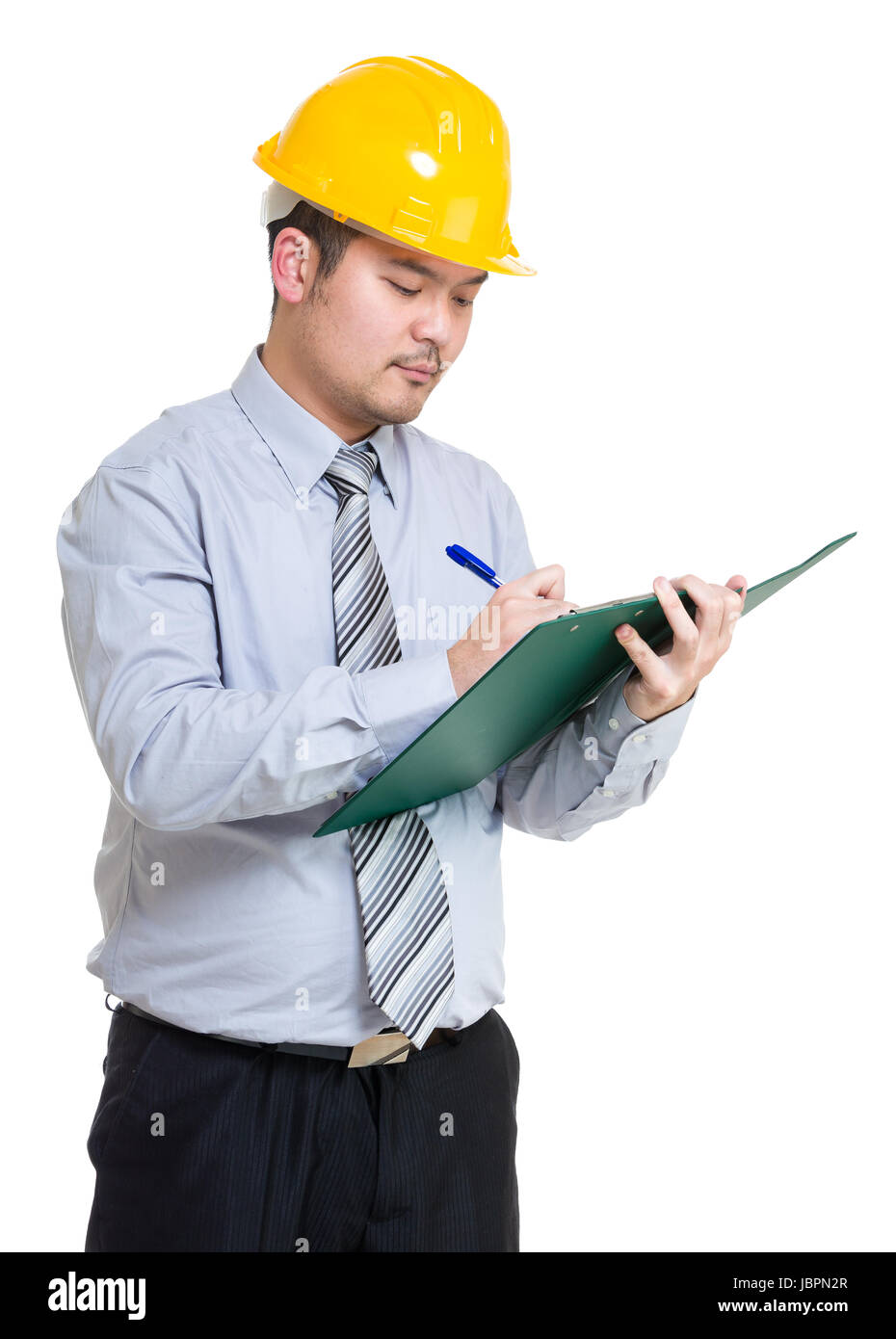 Serious engineer taking note on clipboard Stock Photo - Alamy