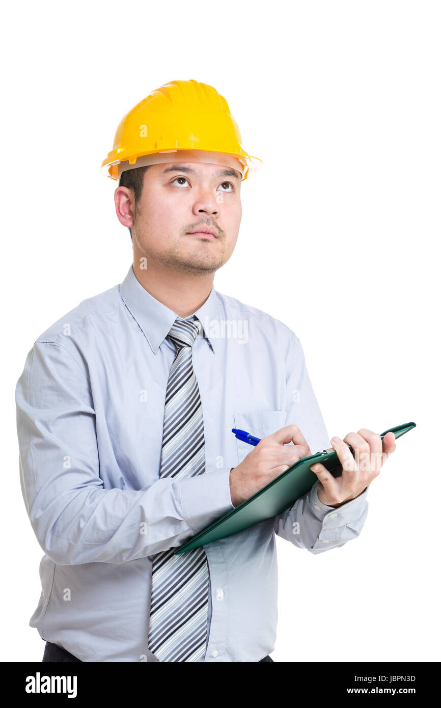 Engineer writing somthing on clipboard and looking up Stock Photo - Alamy