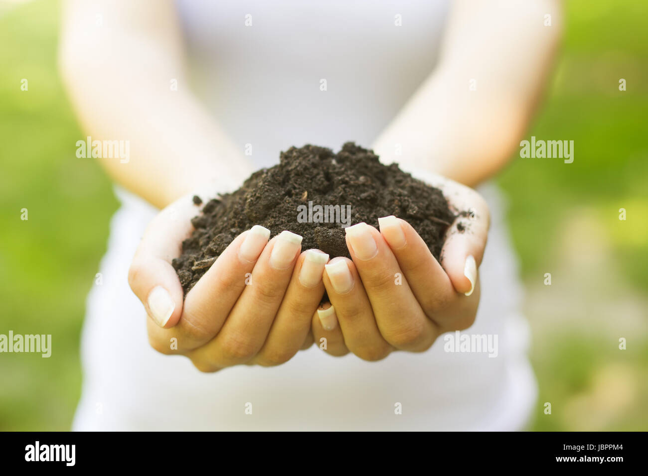 Human hands holding a handful of soil Stock Photo - Alamy