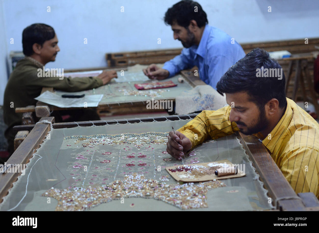 Pakistani workers are busy preparing artificial jewelries at local ...