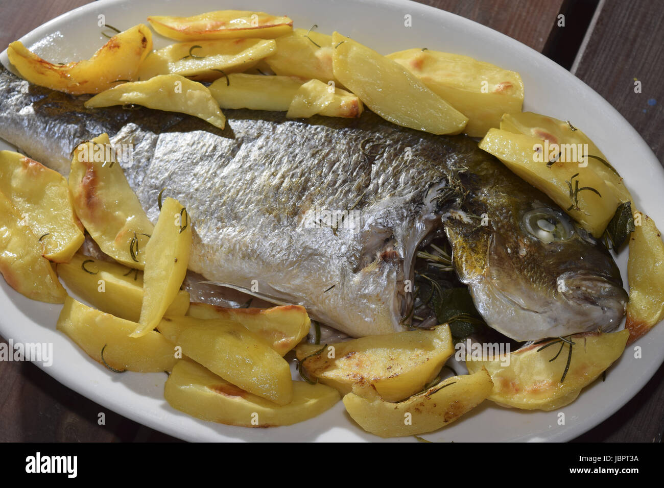 traditinal Italian sea dish: baked sea bream with potatoes Stock Photo ...