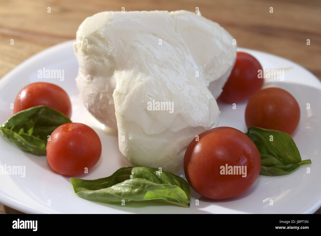 Italian food : mozzarella pachino tomatoes and basil Stock Photo - Alamy