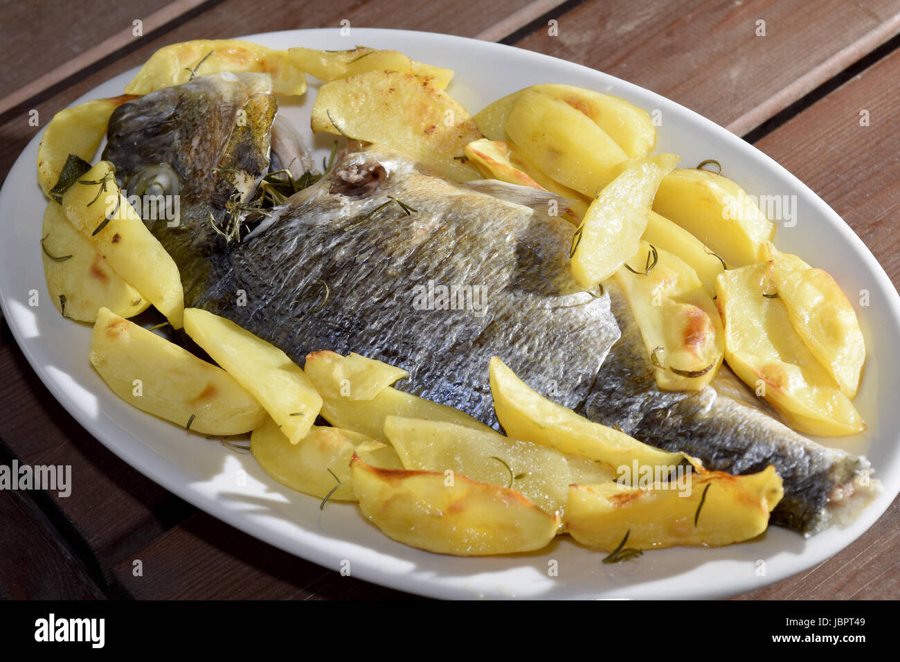 traditinal Italian sea dish: baked sea bream with potatoes Stock Photo ...