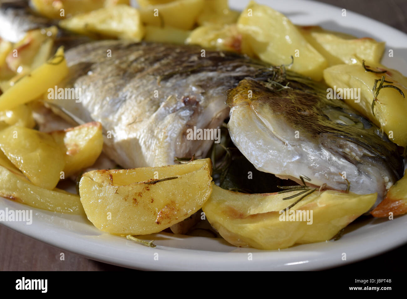 traditinal Italian sea dish: baked sea bream with potatoes Stock Photo ...