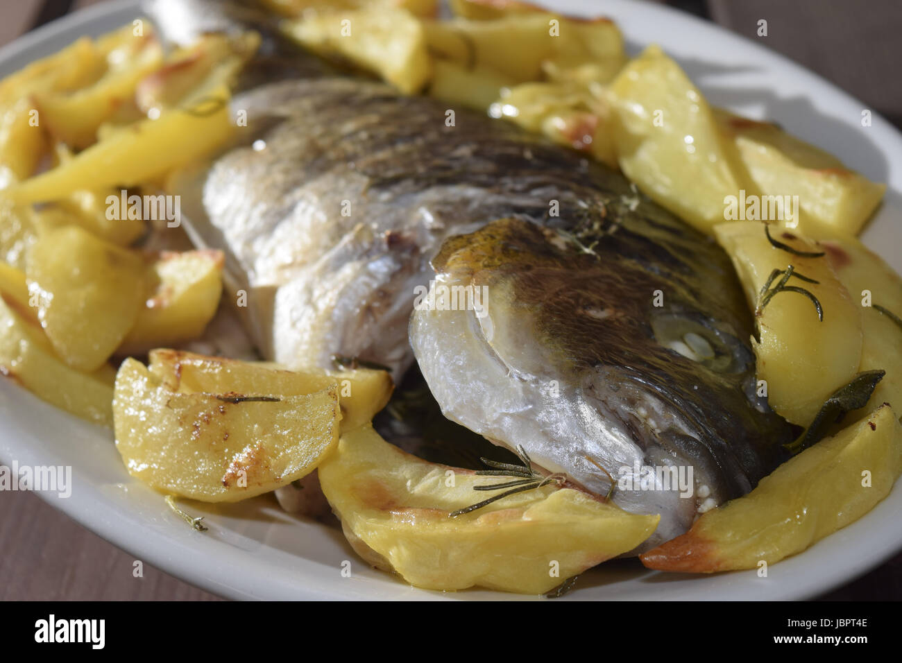 traditinal Italian sea dish: baked sea bream with potatoes Stock Photo ...