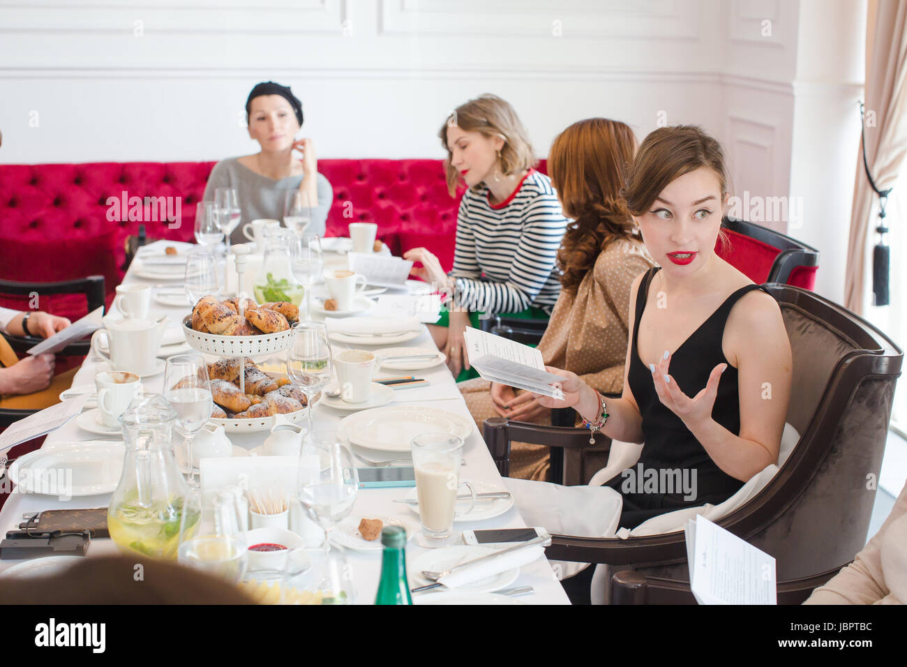 Stylish women sitting table hi-res stock photography and images - Alamy