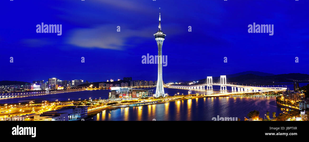 Urban landscape of Macau with famous traveling tower under blue sky ...