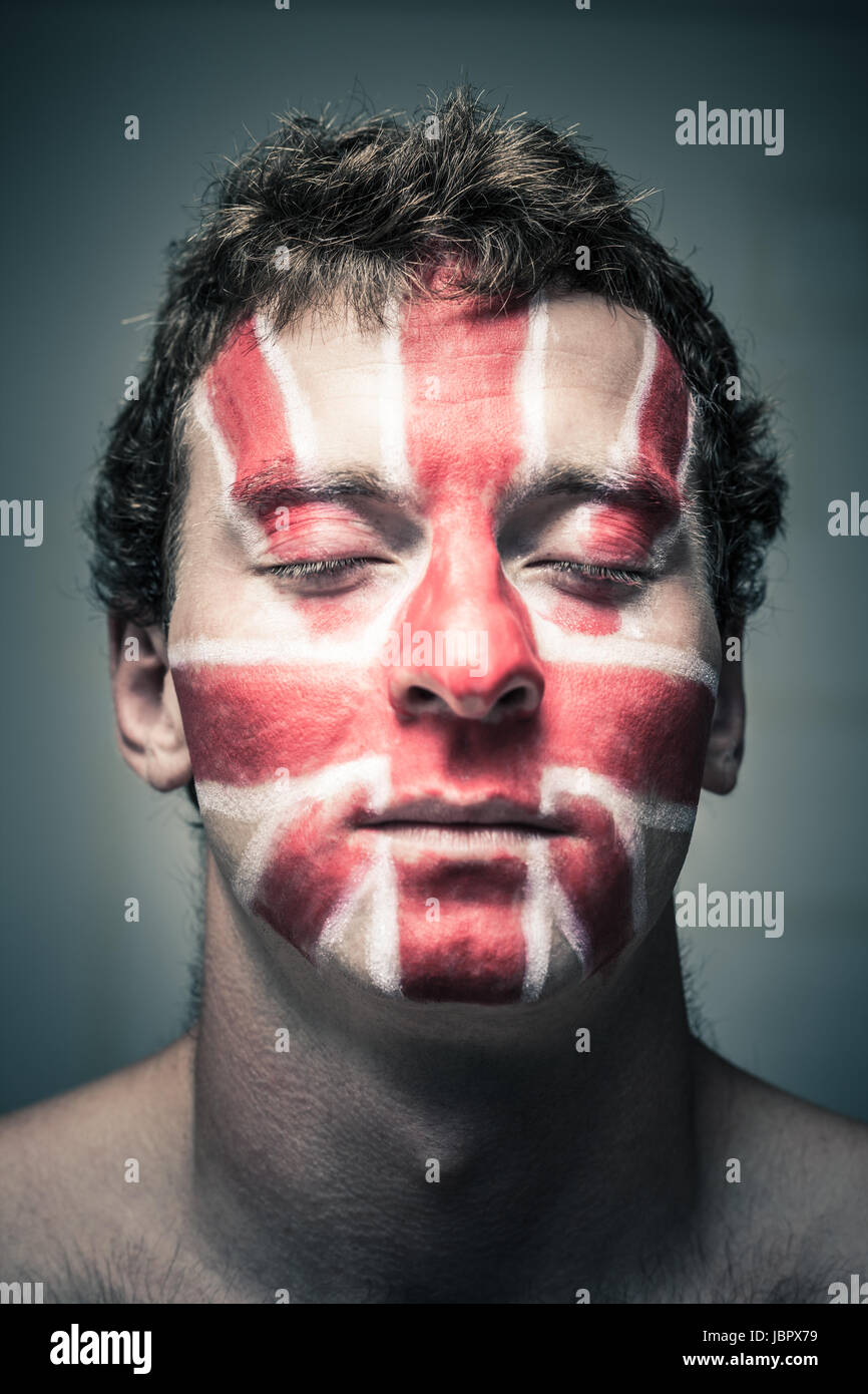 Portrait of man with British flag painted on his face and closed eyes ...
