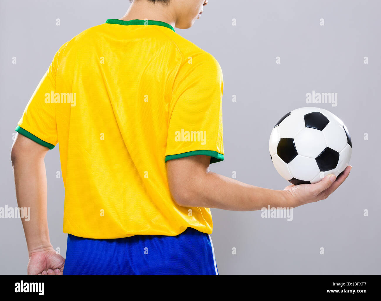 Rear view of football player hold with soccer ball Stock Photo - Alamy