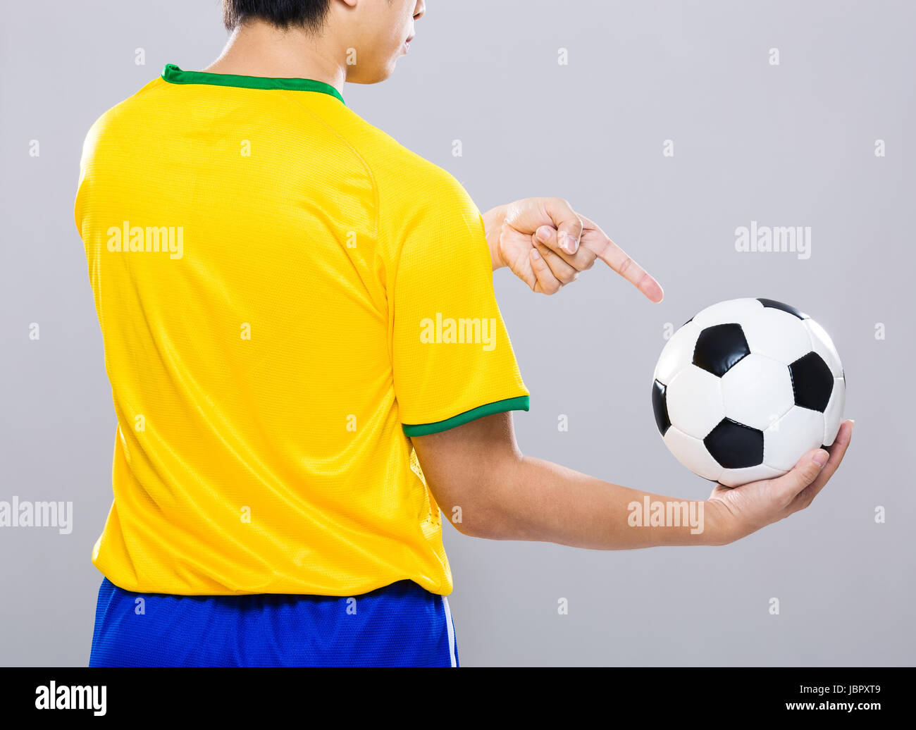 Back view of sportman finger point to soccer ball Stock Photo - Alamy