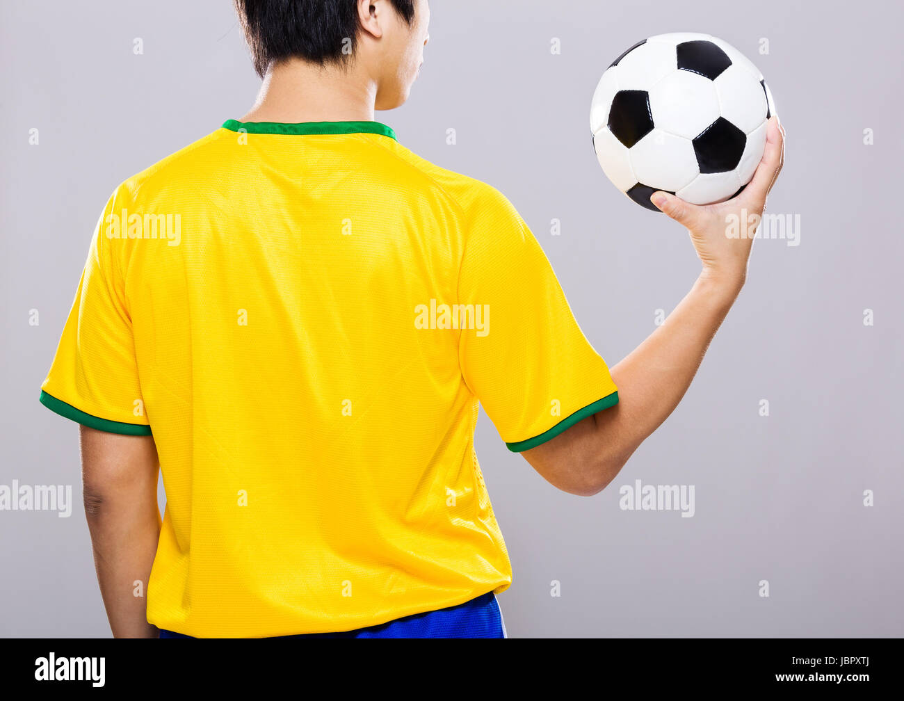 Man hold soccer ball on hand palm Stock Photo - Alamy