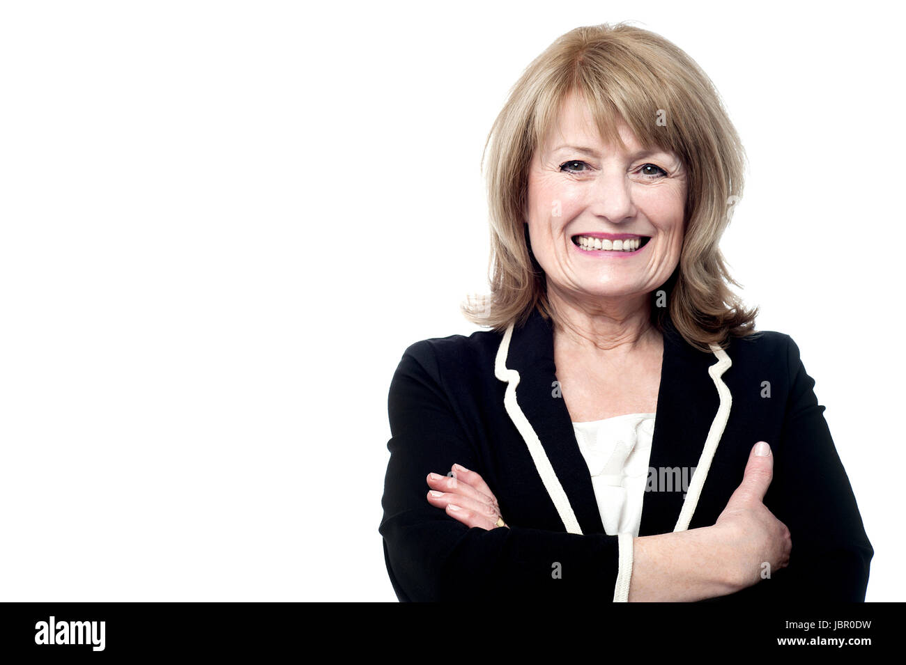 Smiling woman with arms crossed over white Stock Photo - Alamy