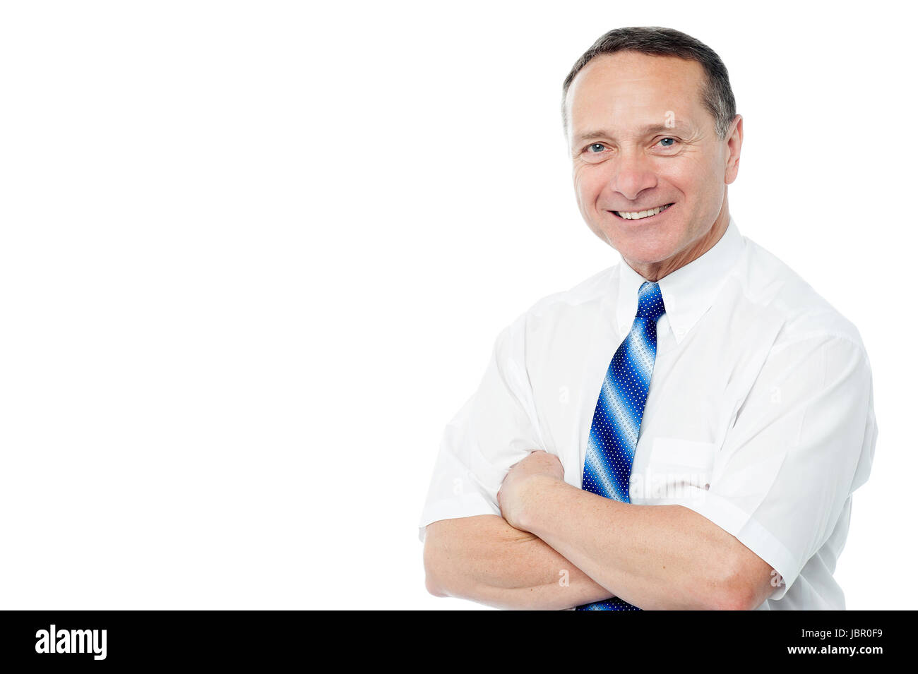 Handsome man posing with arms folded Stock Photo - Alamy