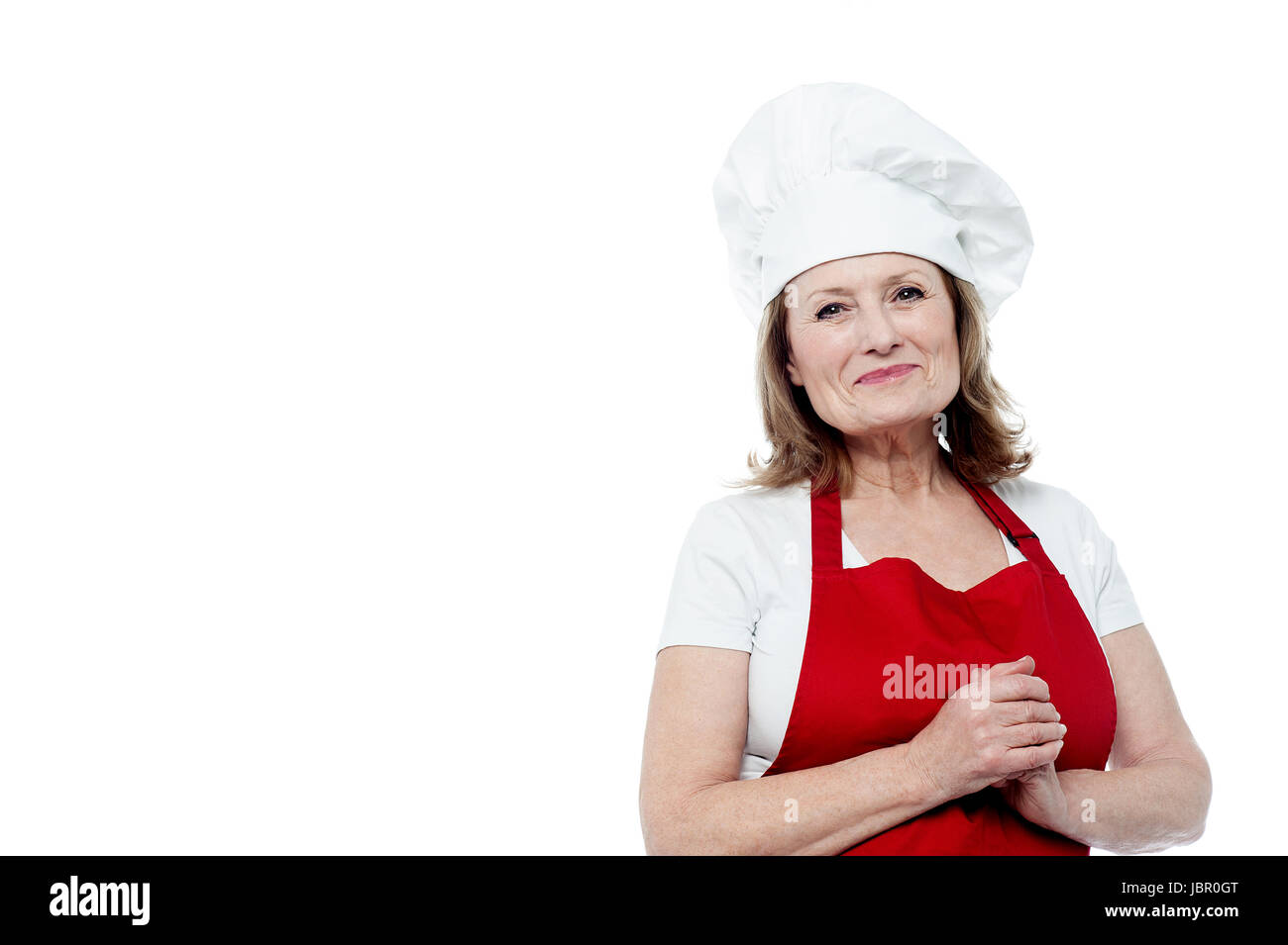 Charming female chef wearing red apron and toque Stock Photo - Alamy
