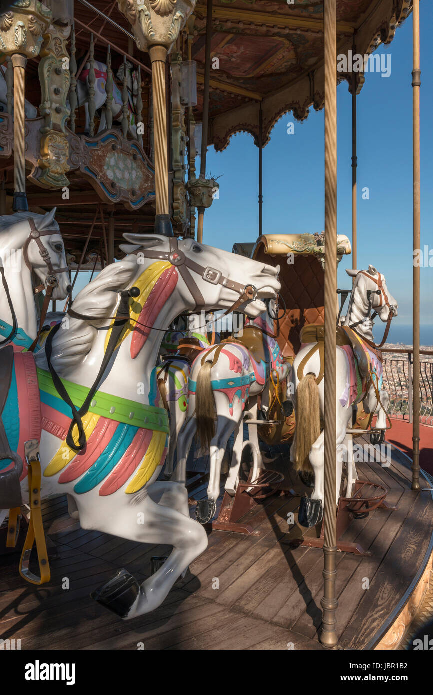 Ride on a century old carousel at Tibidabo Amusement Park provides ...