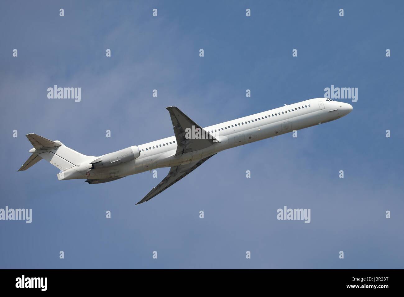 Airplane flying away to the blue sky Stock Photo - Alamy