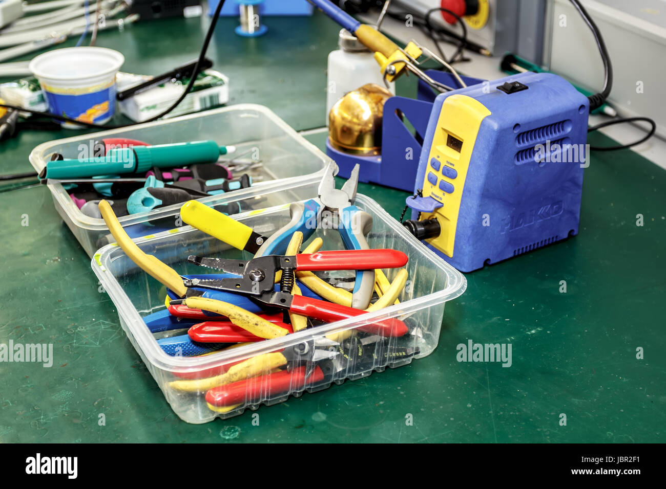 electronics equipment assembly workplace with pliers and necessary ...