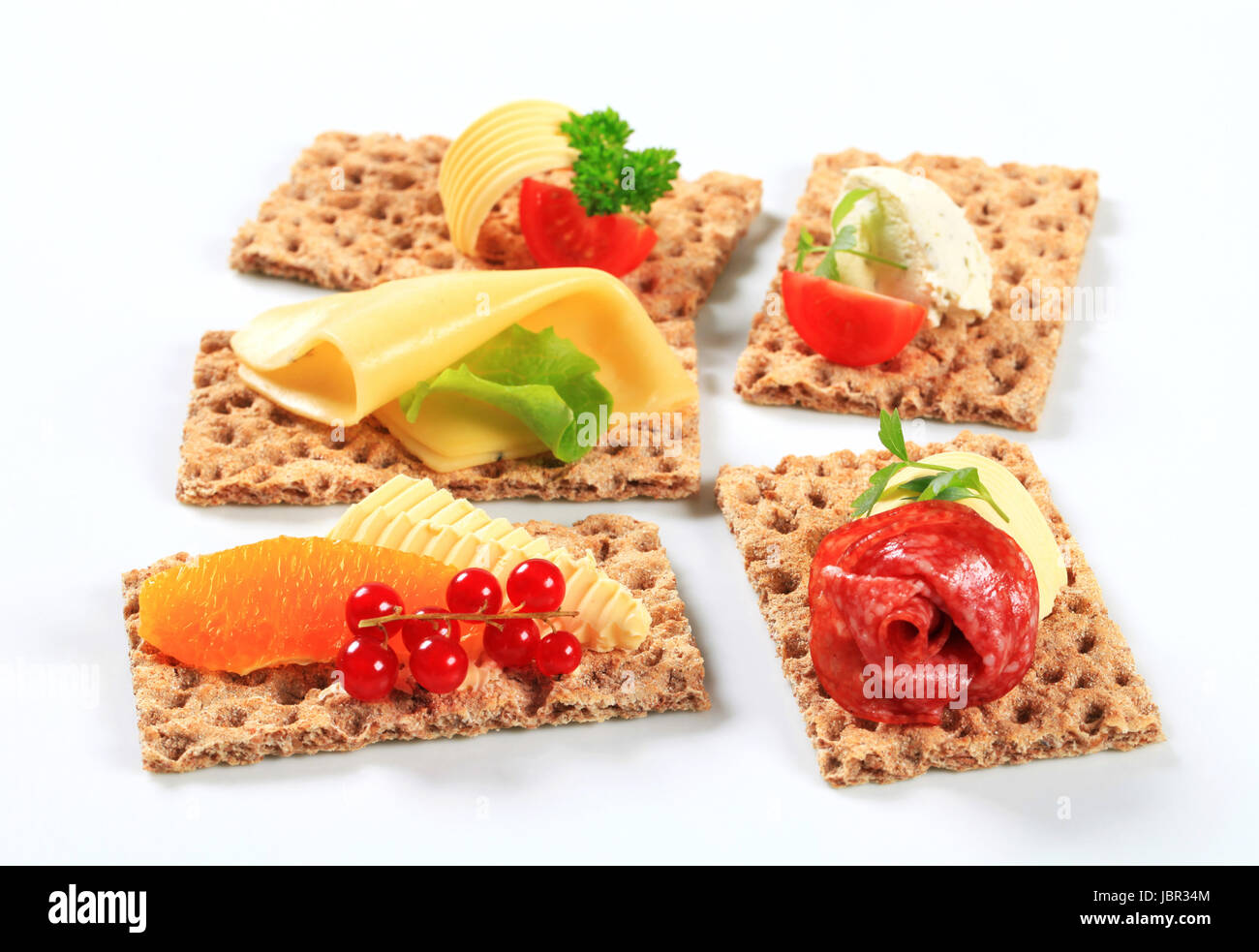 Whole grain crisp bread slices with various toppings Stock Photo - Alamy