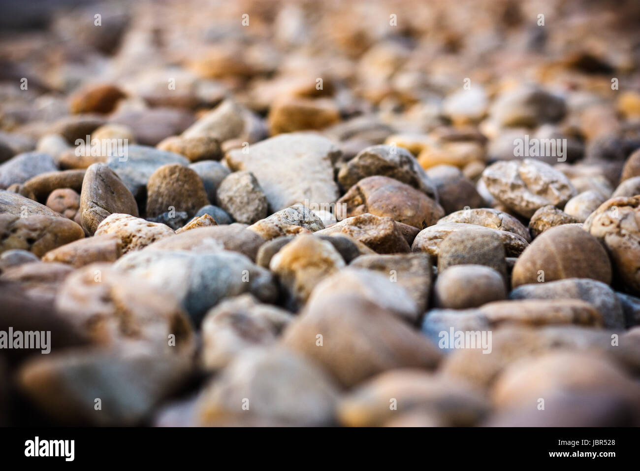 Small stones on the ground Stock Photo - Alamy