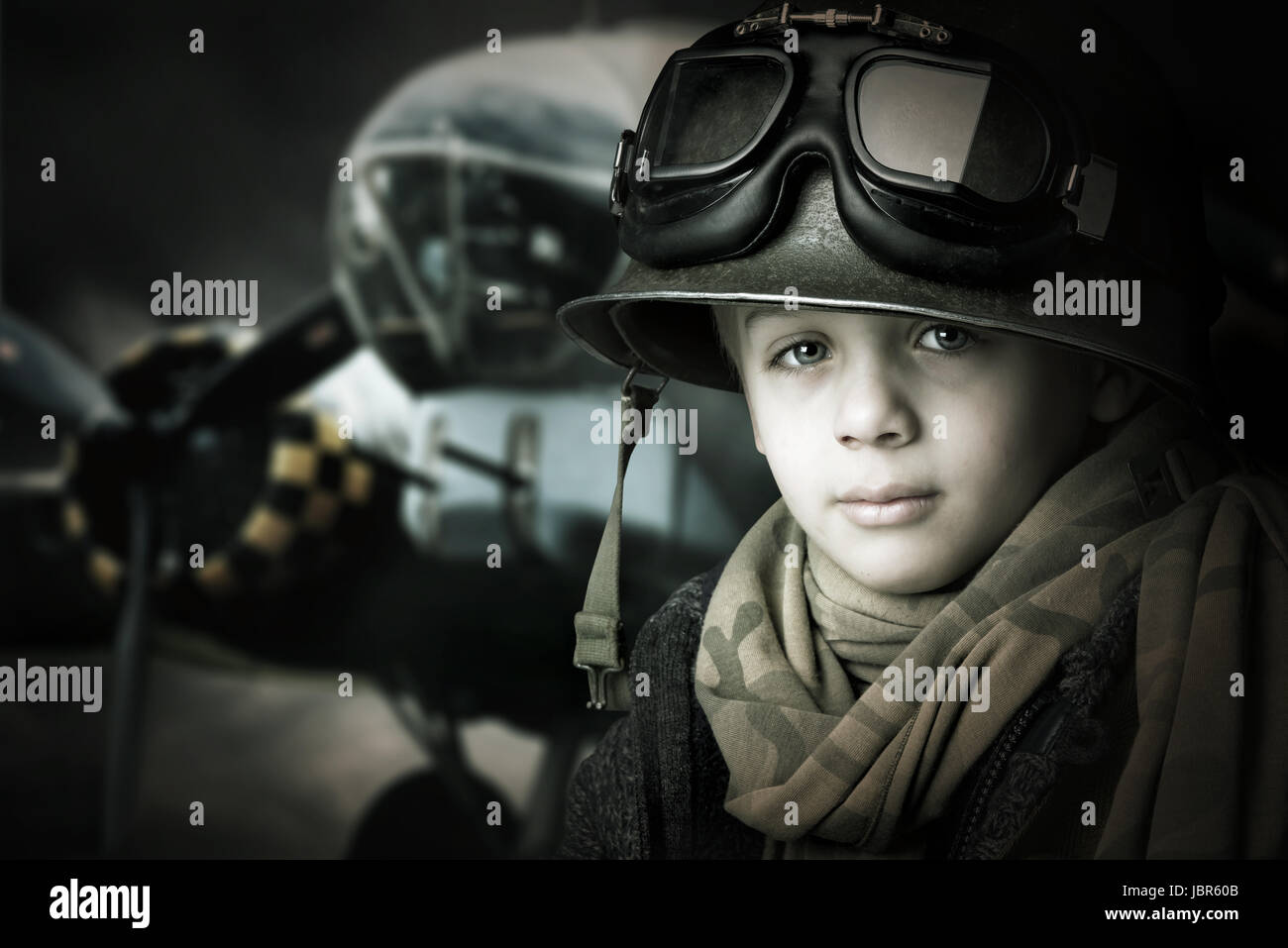 Young boy soldier in a dark background Stock Photo - Alamy